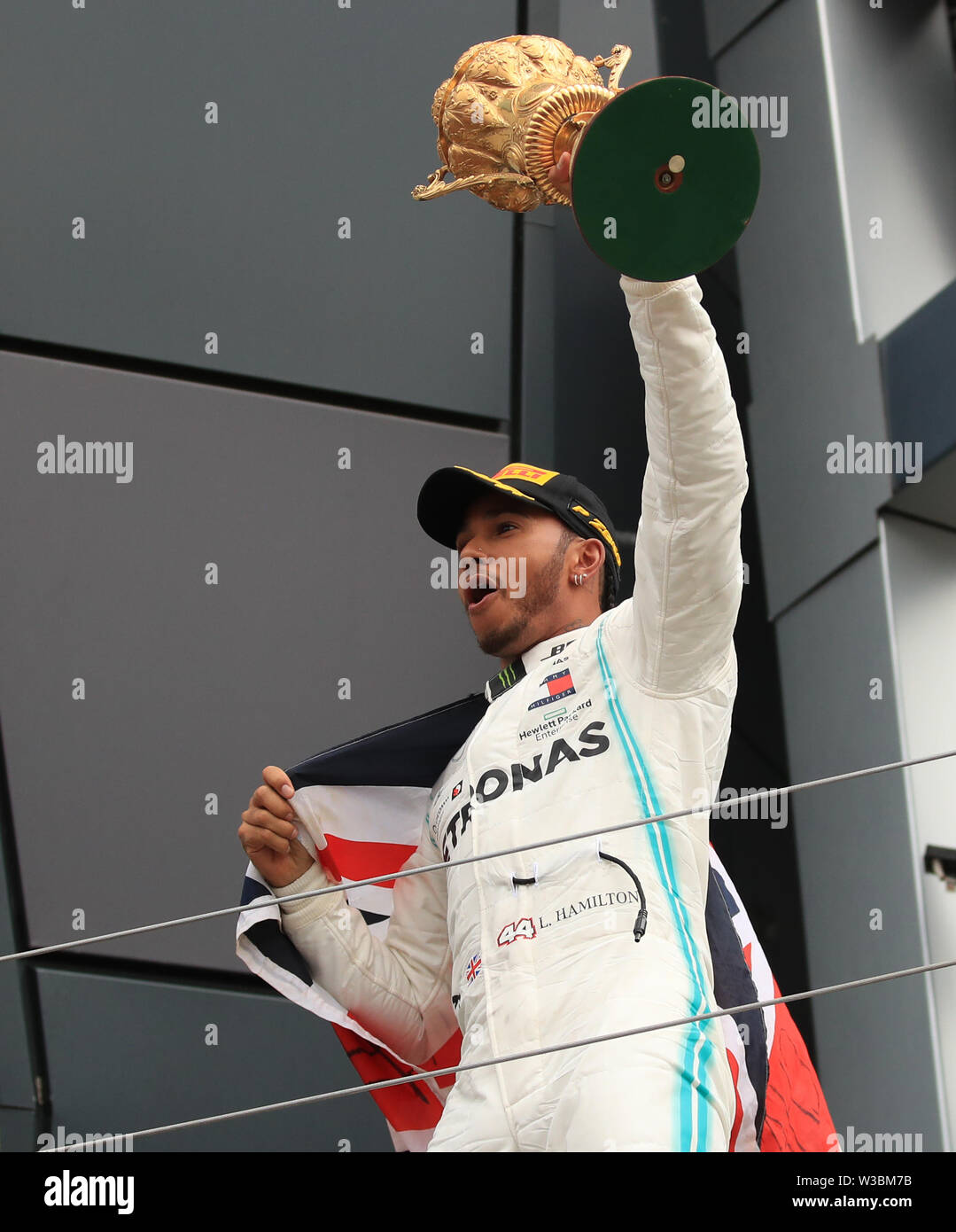 Mercedes driver Lewis Hamilton celebrates victory on the podium during ...