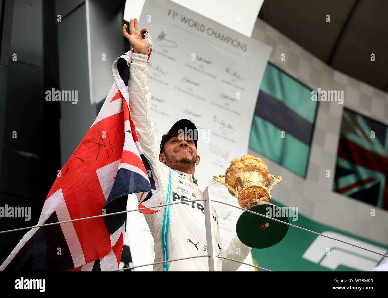 Mercedes driver Lewis Hamilton celebrates victory on the podium during ...