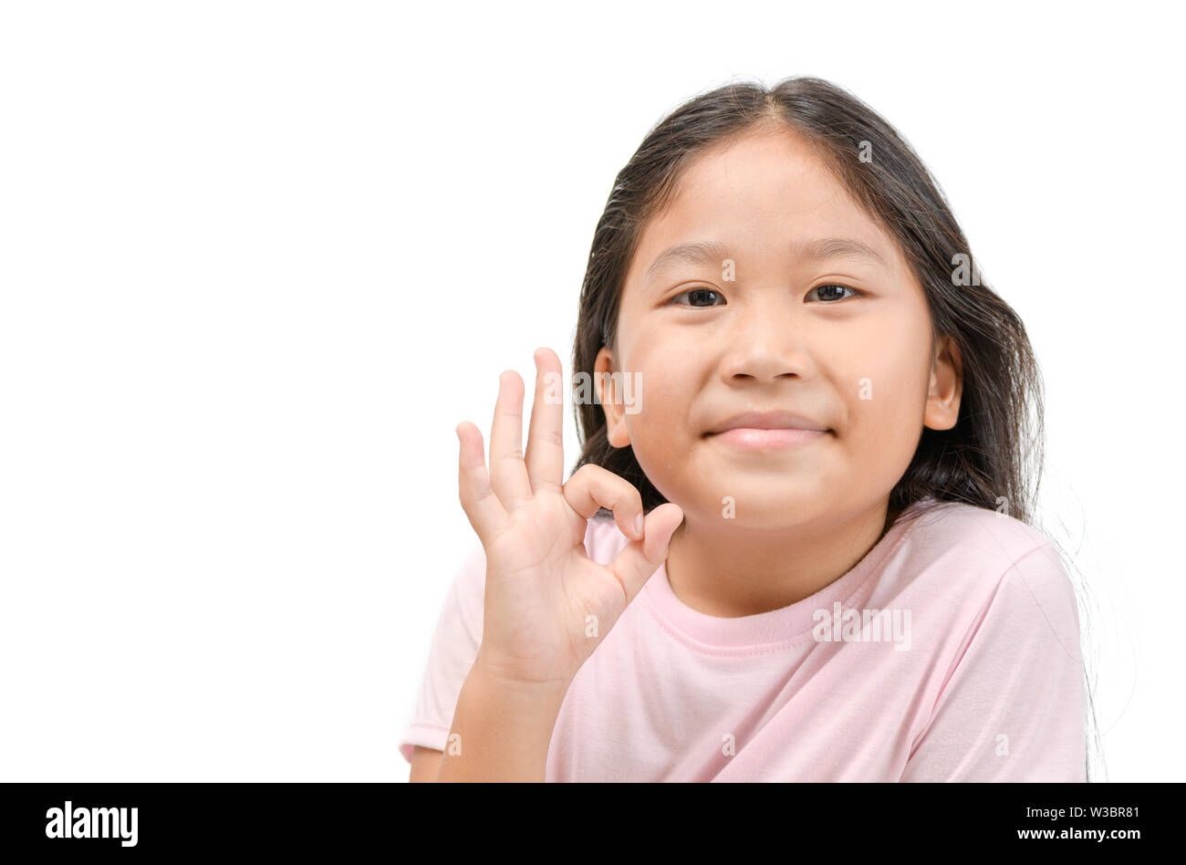 Portrait of a cute little girl kid showing okay gesture isolated over ...
