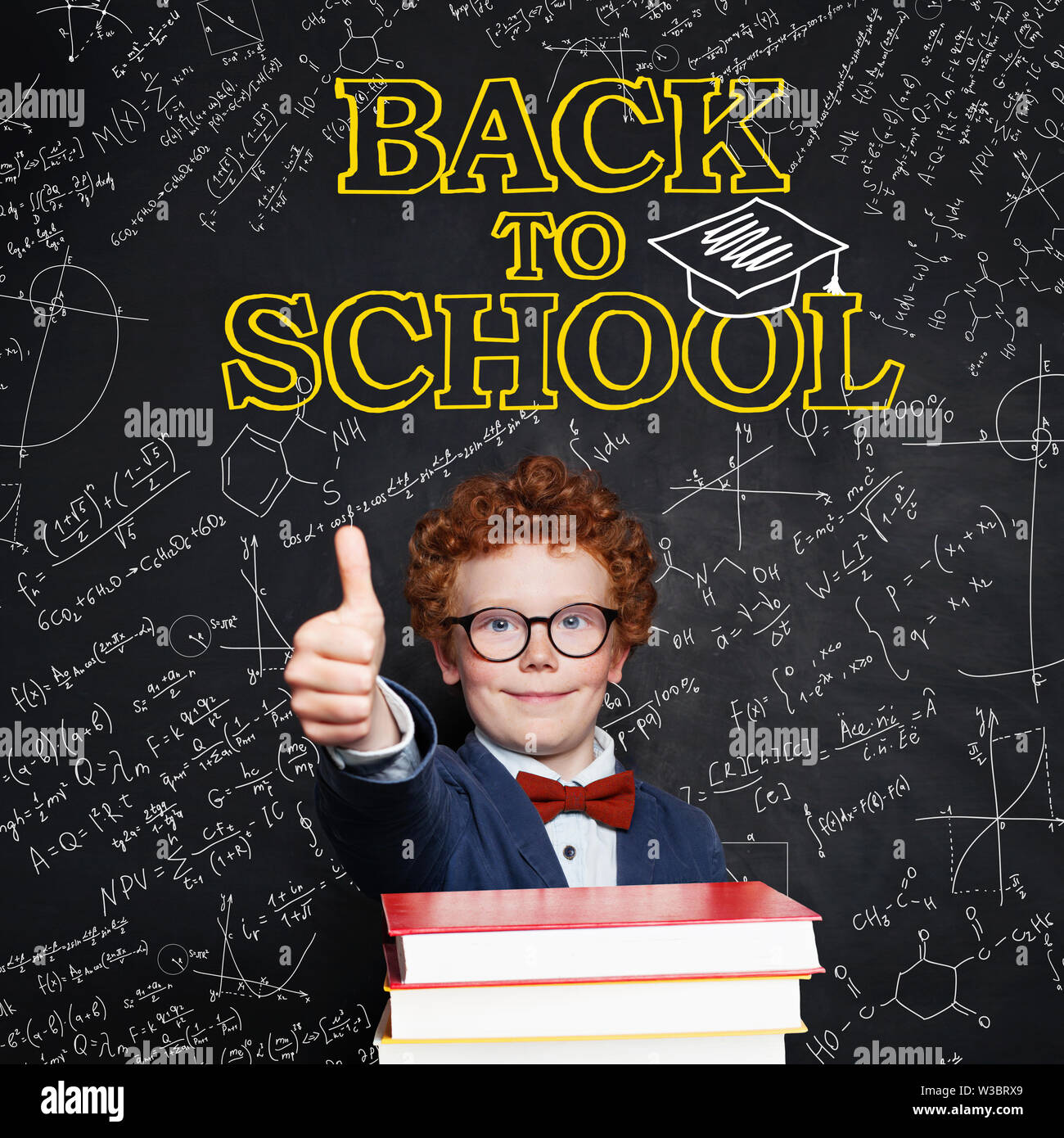 Kid student having fun against blackboard background. Back to school ...