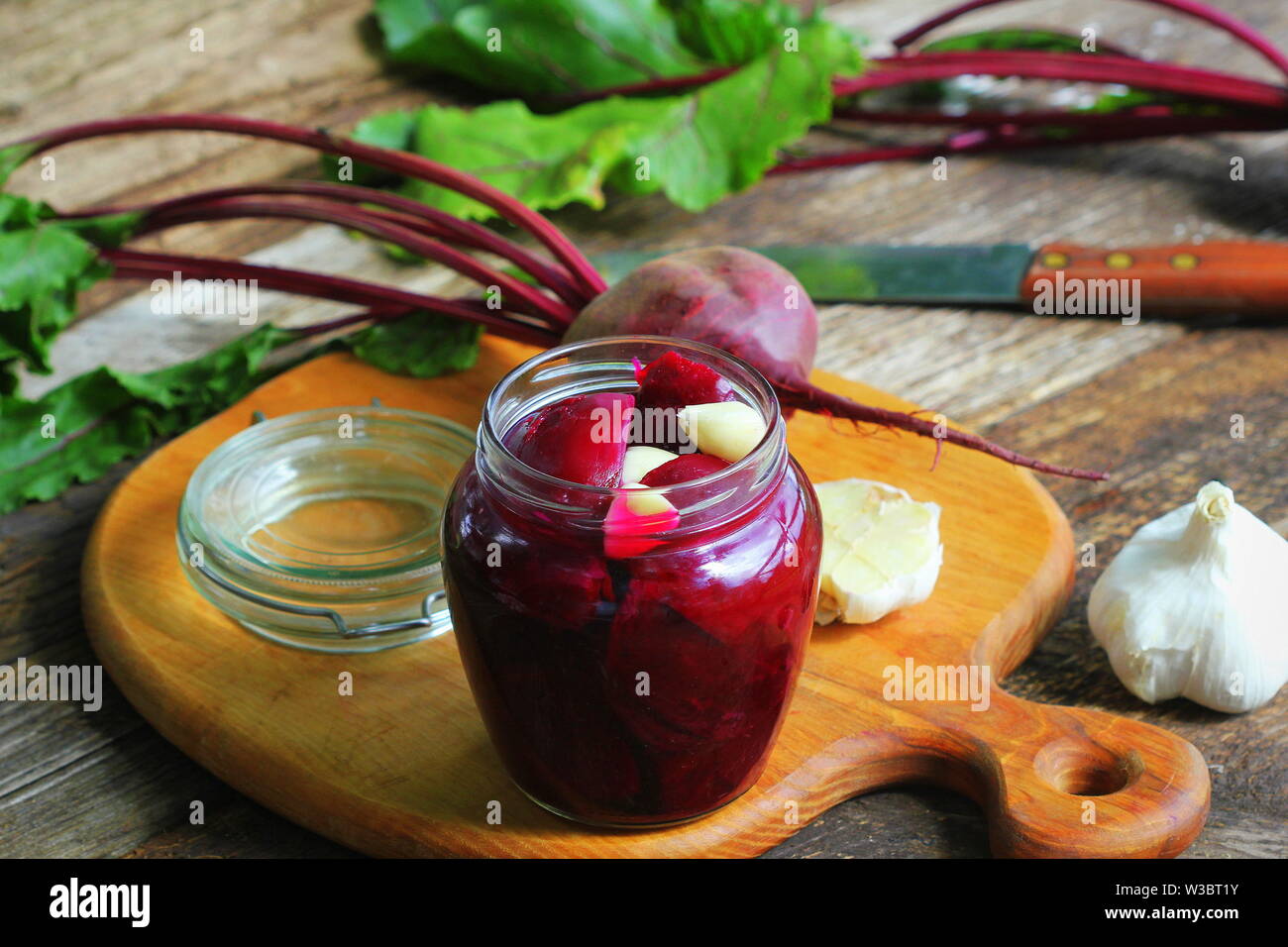 Pickled beets in the jar on a dark wood background Stock Photo - Alamy