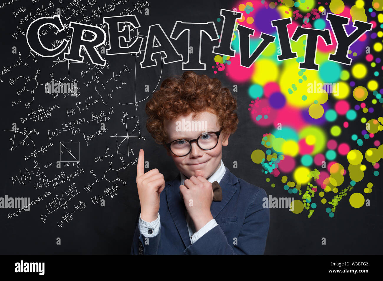 Thinking kid boy in glasses and blue suit on background with creativity ...
