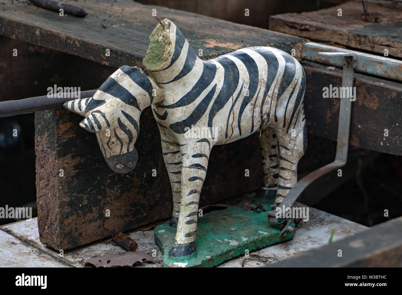 The damaged statue of zebra with a falling head, close up Stock Photo ...