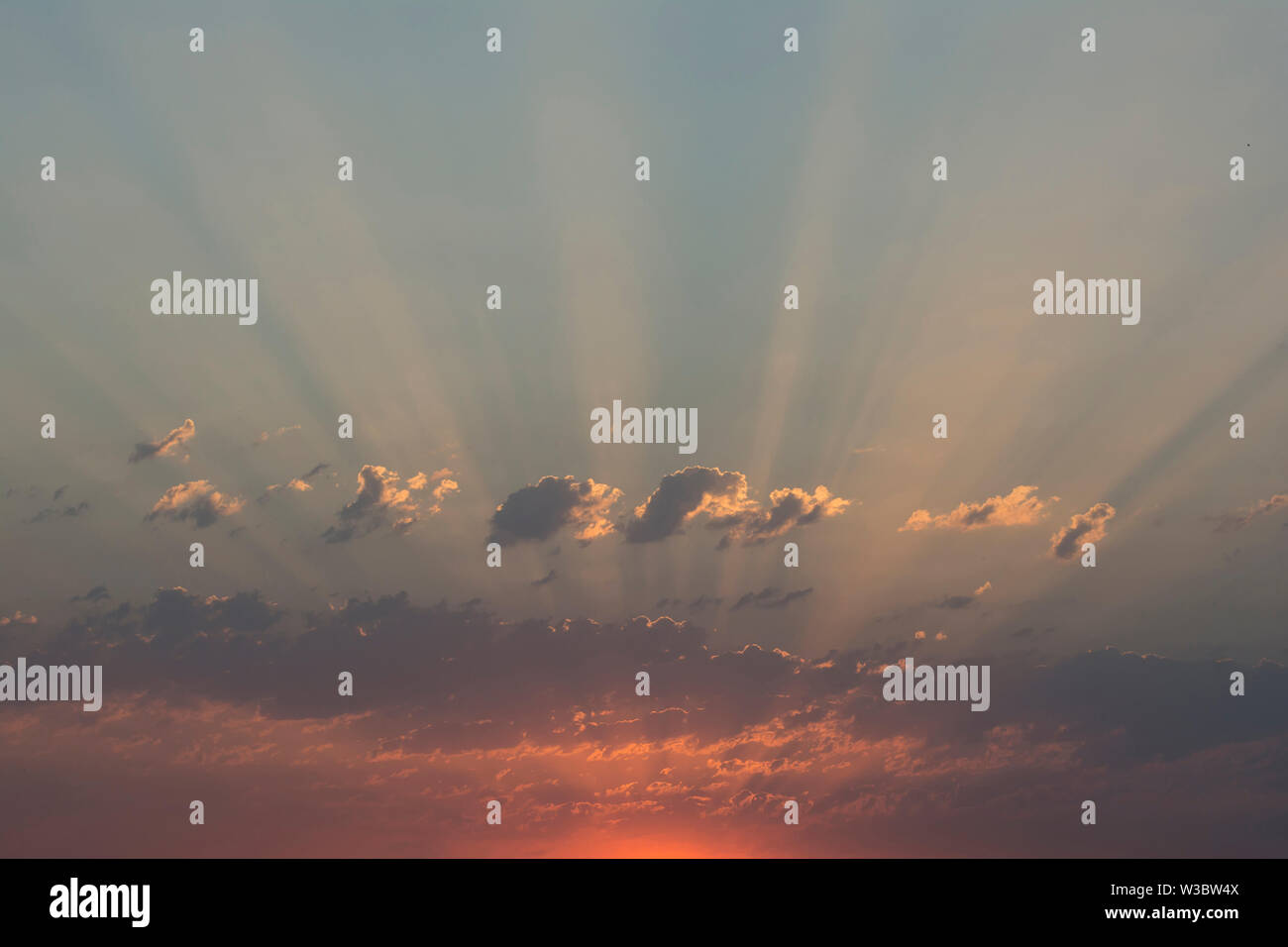Morning sunrise light rays with dramatic clouds at sky Stock Photo - Alamy