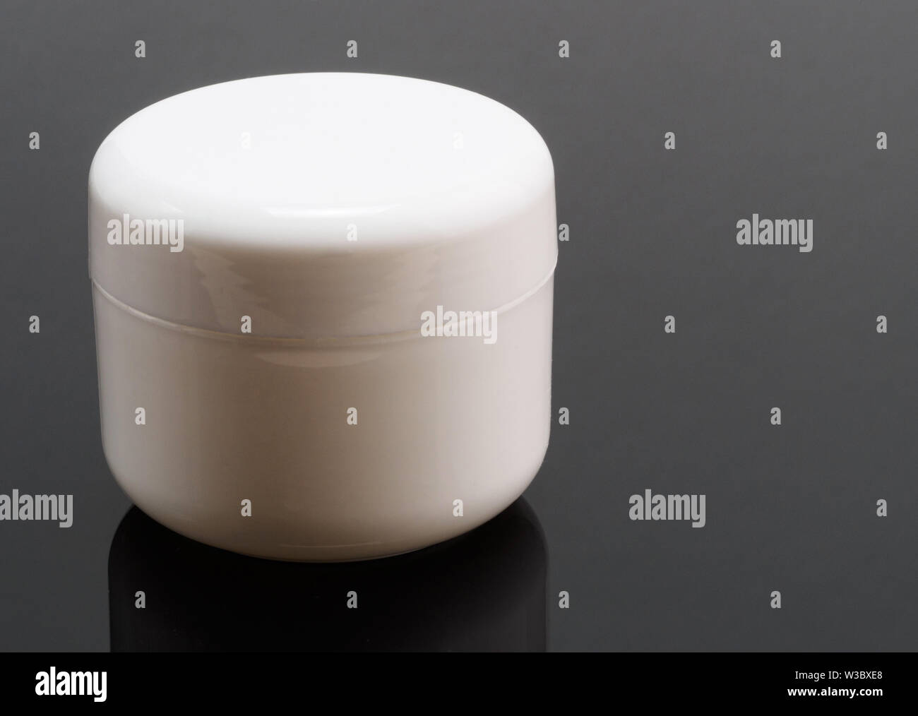 White cup for cosmetic products isolated on black background Stock ...