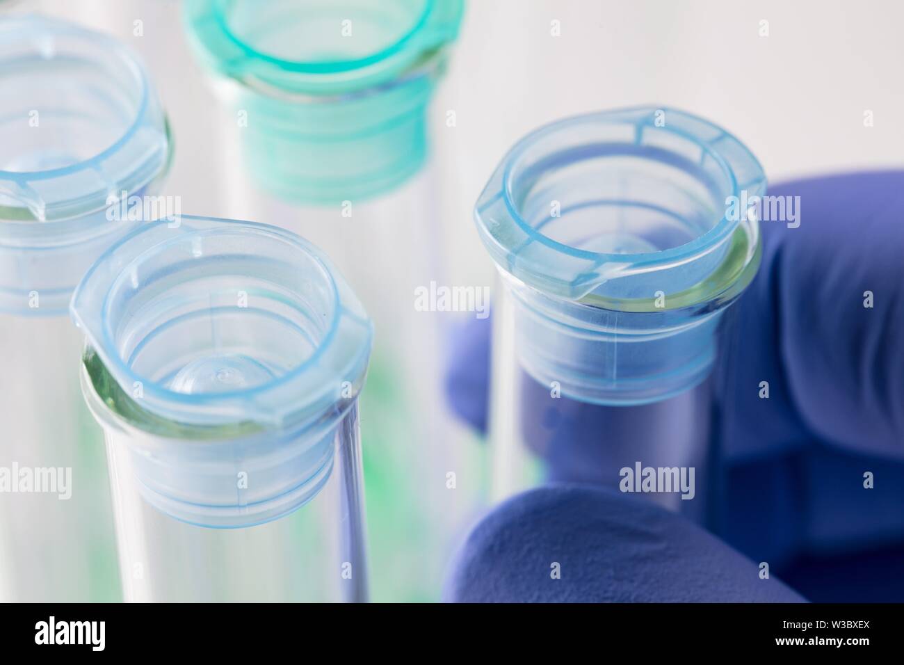 A man holding test tubes in a laboratory Stock Photo - Alamy