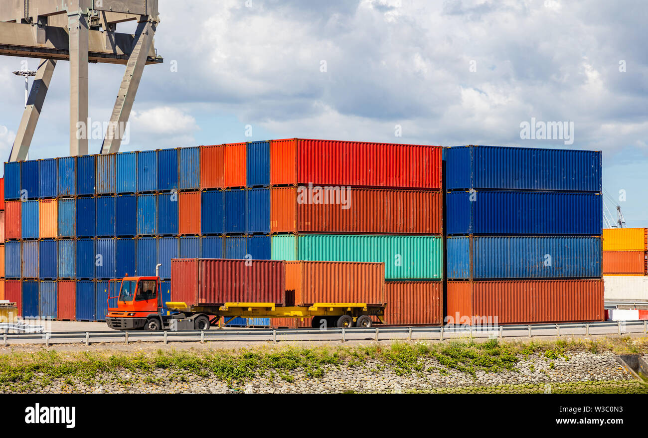 Logistics business. Stacked containers, crane and truck, international ...