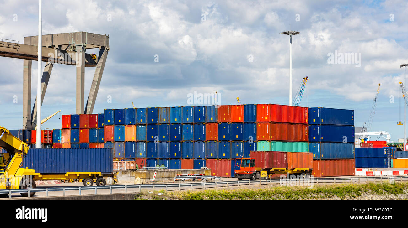 Logistics business. Stacked containers, cranes and trucks ...