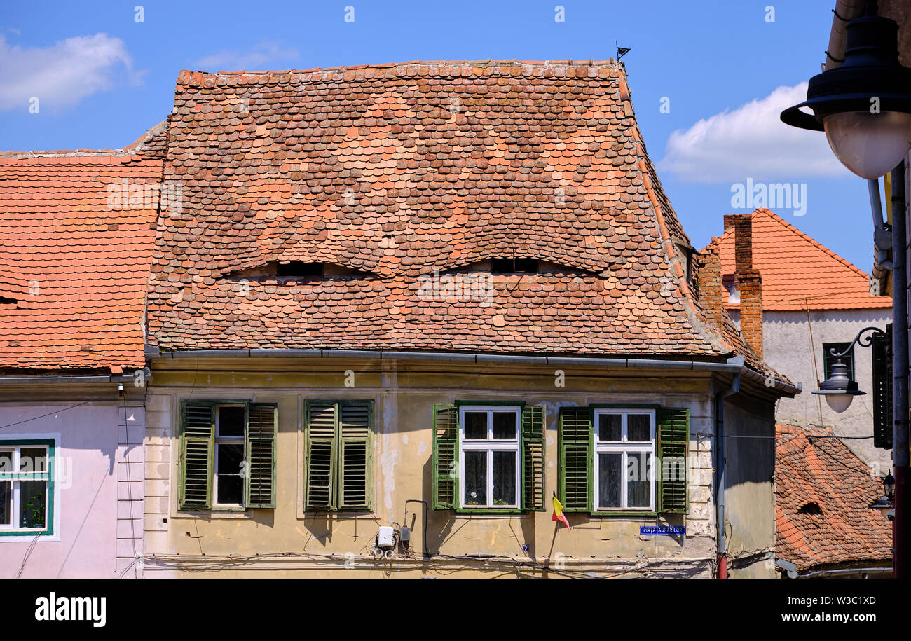 Typical Romanian roof top with lucarnes appearing like eye on the roof ...