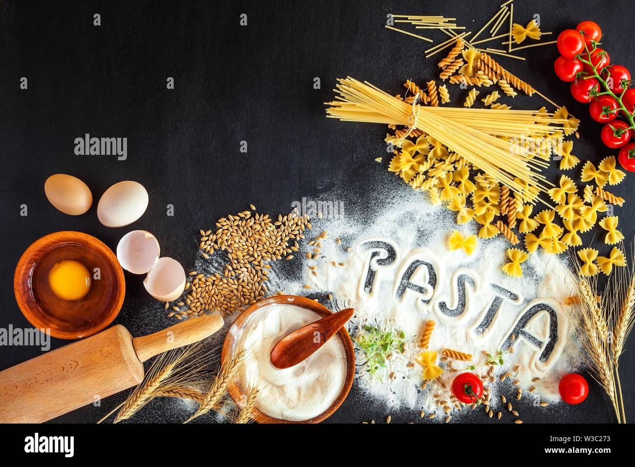 Home made traditional pasta. Flour grain egg pasta on black background ...