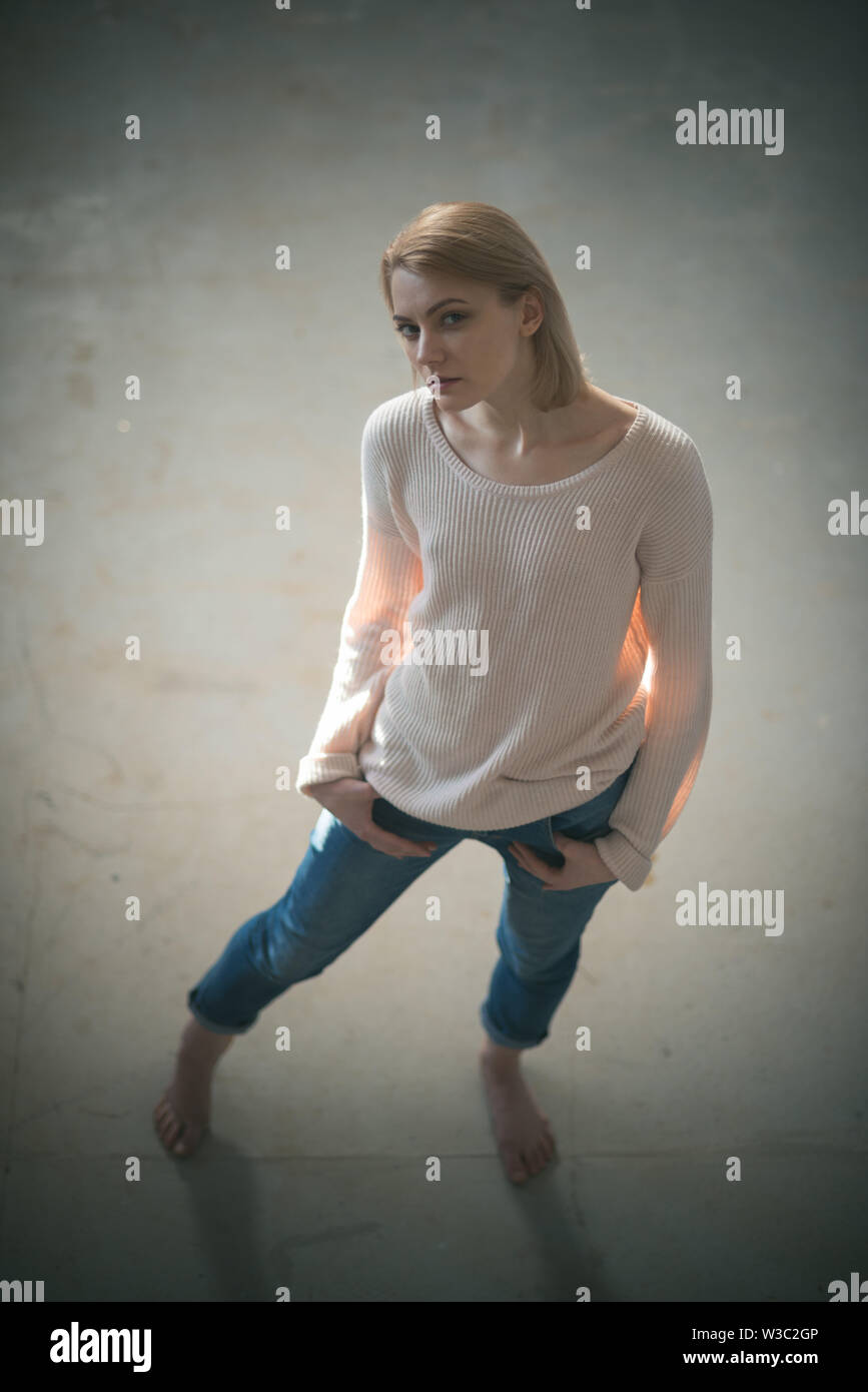 lonely girl at home standing barefoot. thoughtful woman at home ...