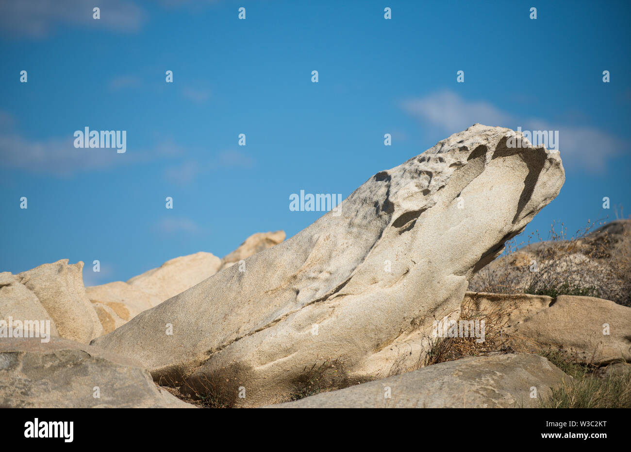 Stones on blue sky background. Rock on sunny outdoor. White solid layer ...