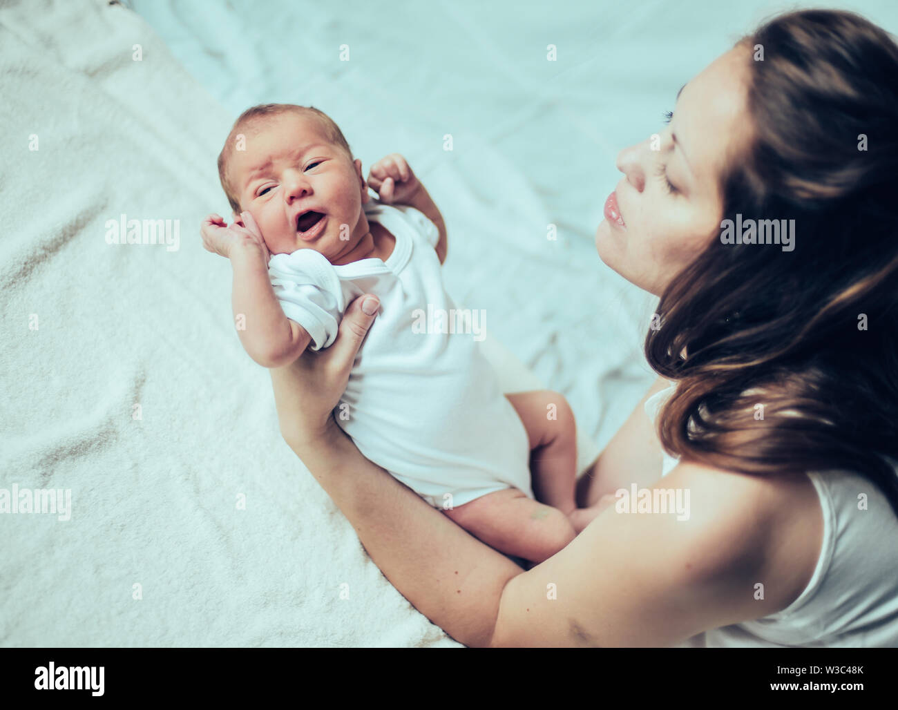 mother with her newborn baby .the photo has a empty space for your text ...