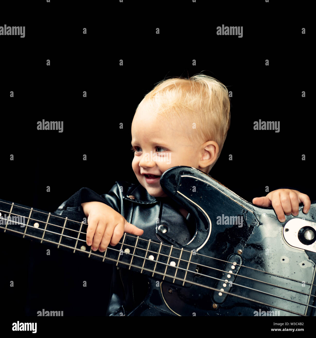 Music is fun. Small musician. Little rock star. Child boy with guitar ...