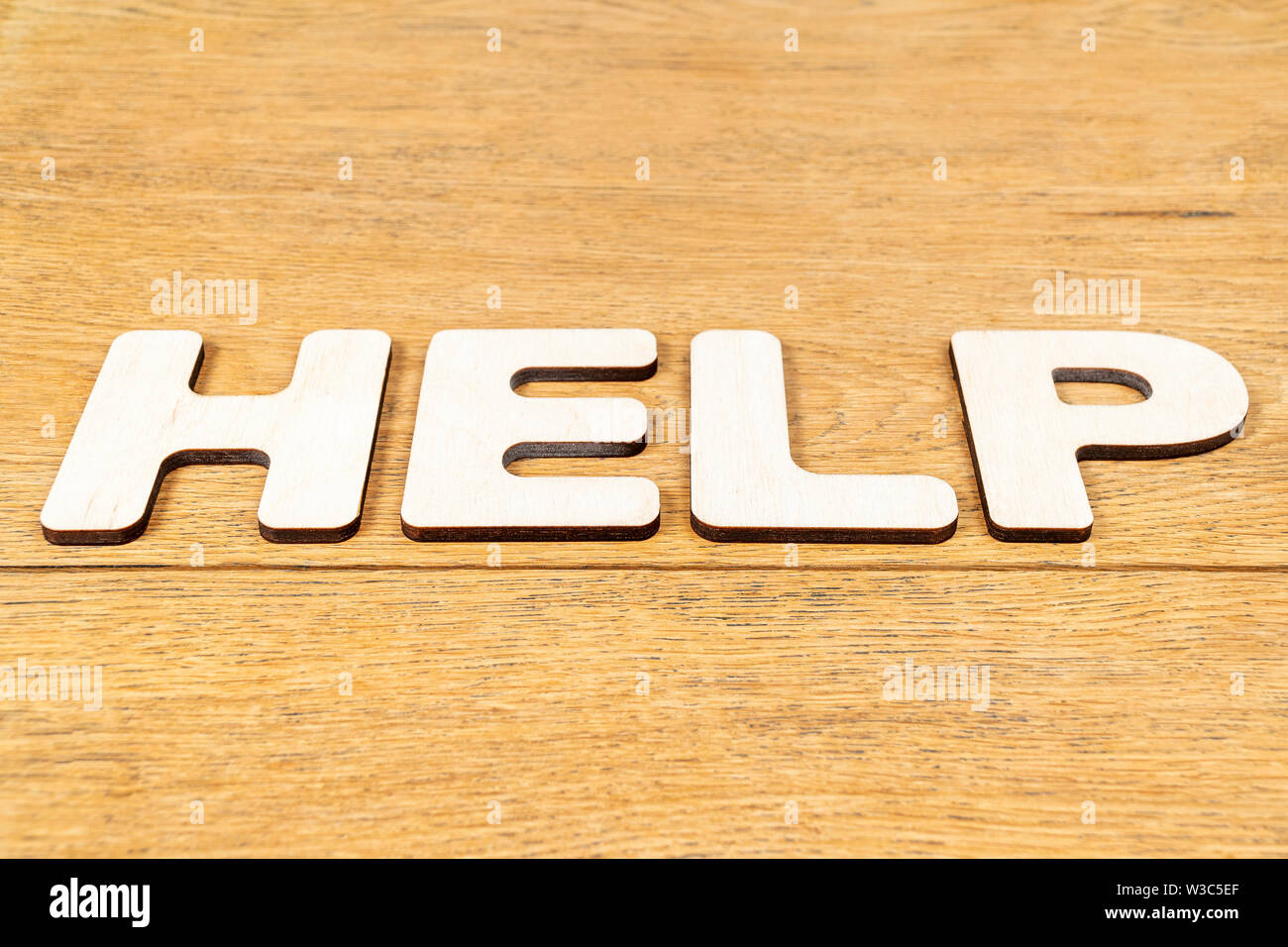 Word - help, laid out in wooden letters on an old wooden table Stock ...