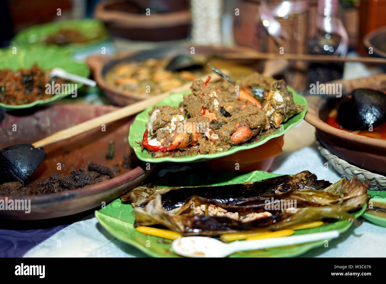 Dining table filled with Chilli crab, fish curry and many seafood Stock ...