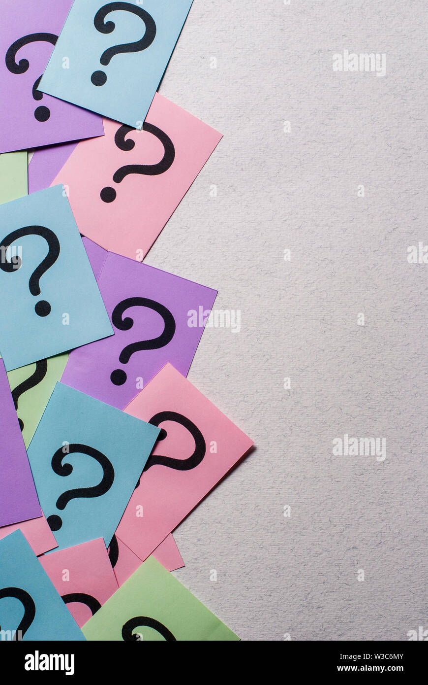 Side border of colorful question marks on multicolored paper in a ...
