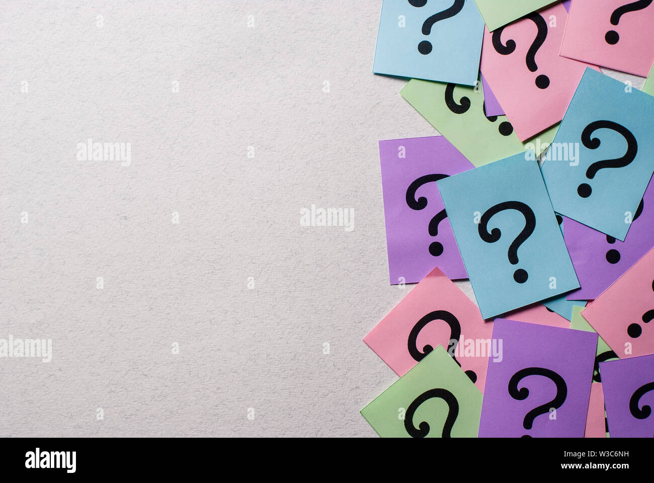 Side border of colorful question marks on multicolored paper in a ...