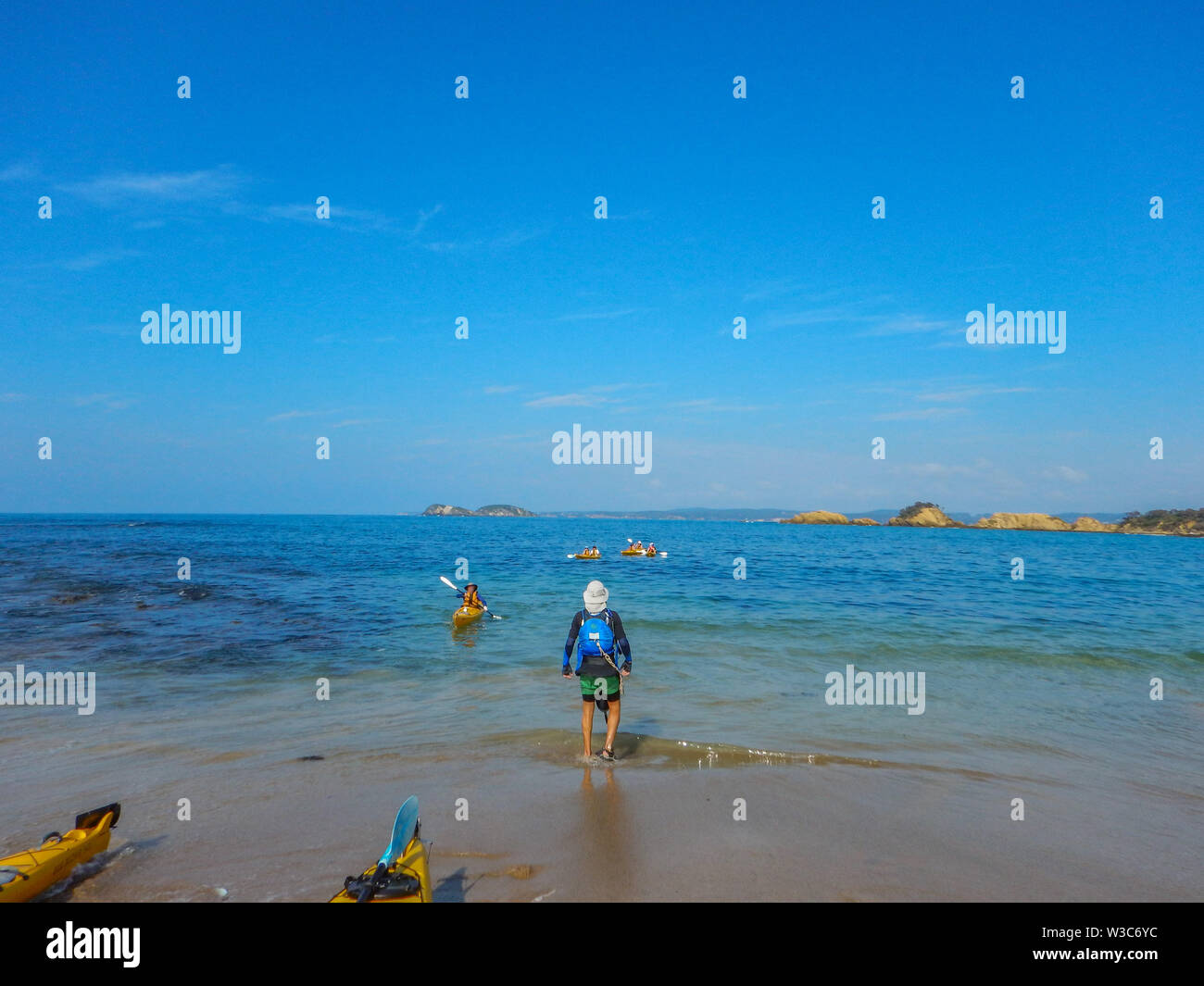 Kayak tour group coming into beach where guide is waiting, NSW ...