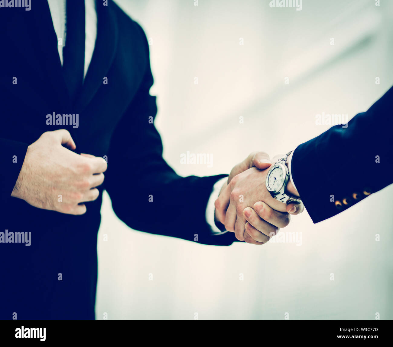 in the foreground - handshake of business partners on background of ...