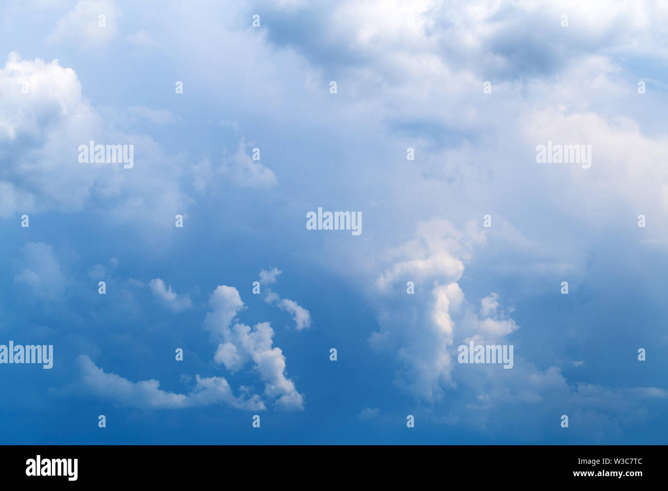 Blue sky background with solid clouds Stock Photo - Alamy