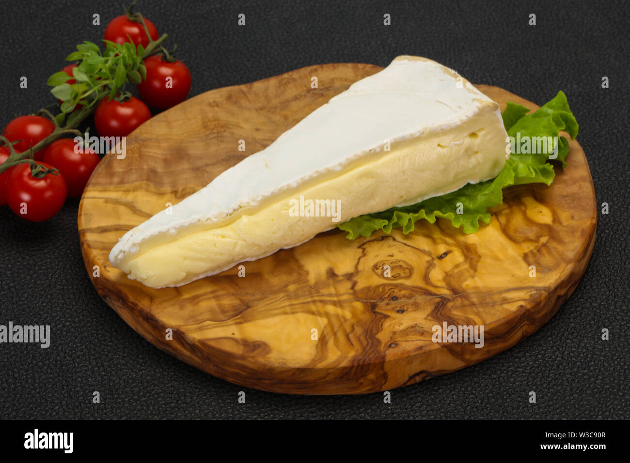 Brie cheese triangle served salad leaves Stock Photo - Alamy