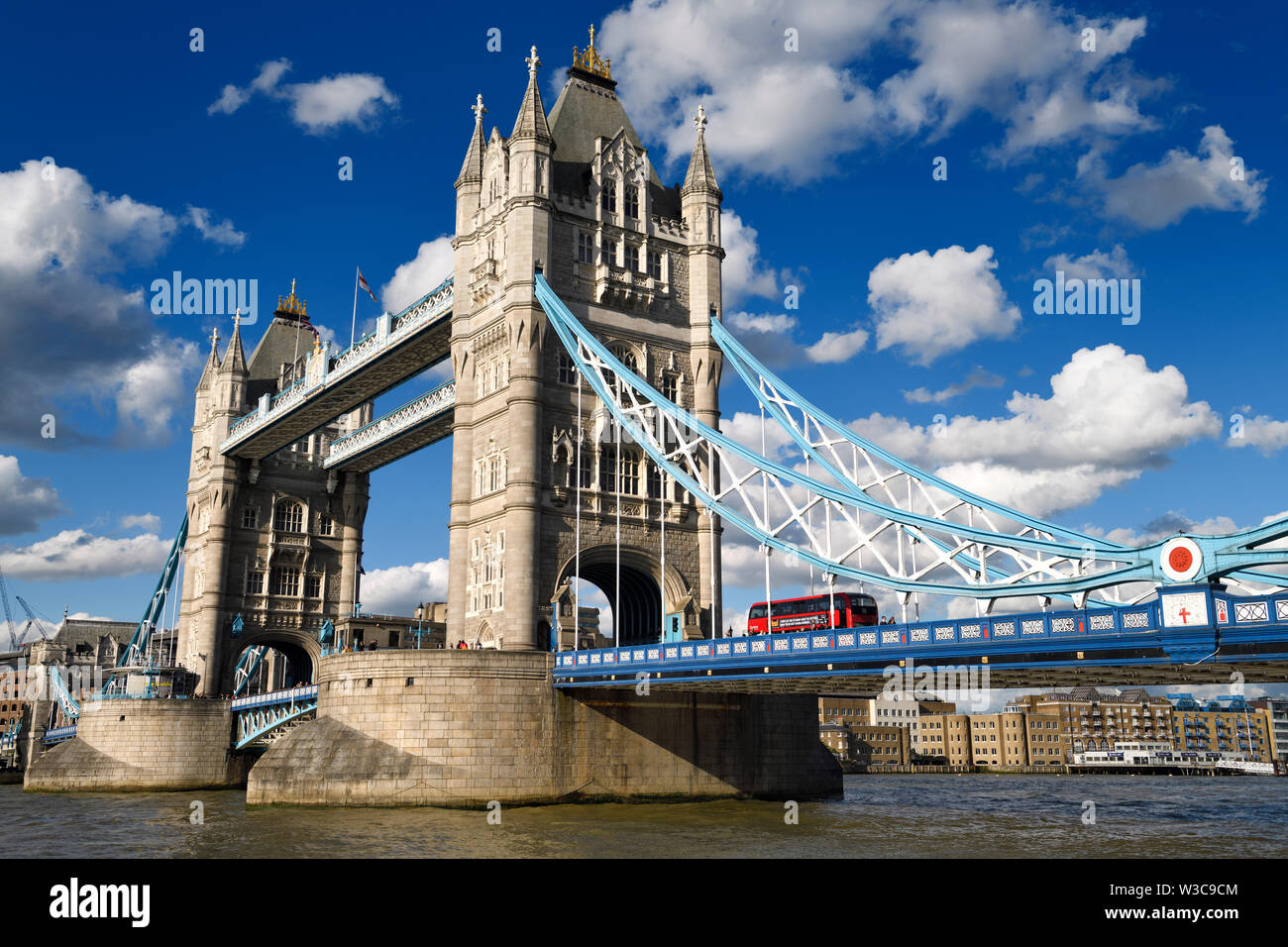 Twin stone towers of Tower Bridge over the Thames River in London with ...