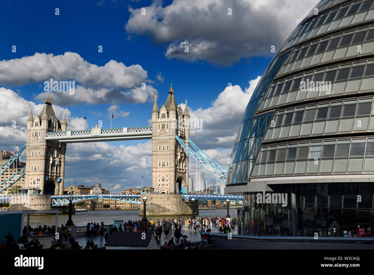 Twin stone towers of Tower Bridge over the Thames River in London with ...