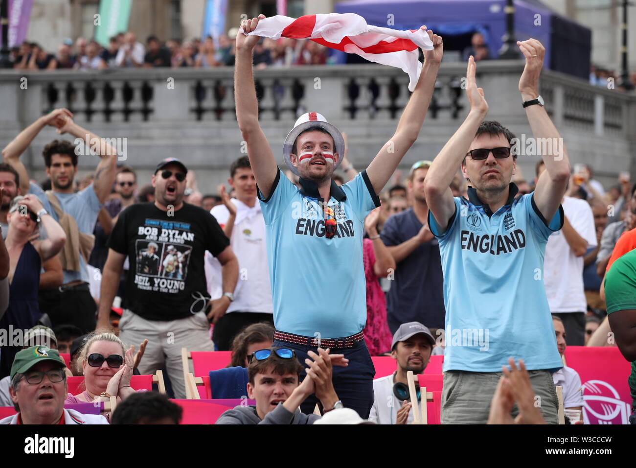 England and New Zealand fans react as they watch a big screen in the ...