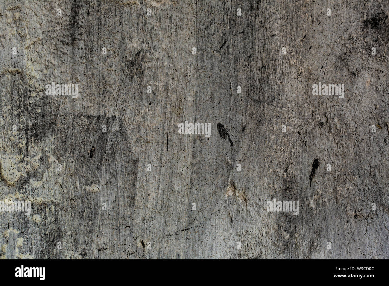 Dirty burnt gray wall detail with dominantly black and white colors as ...