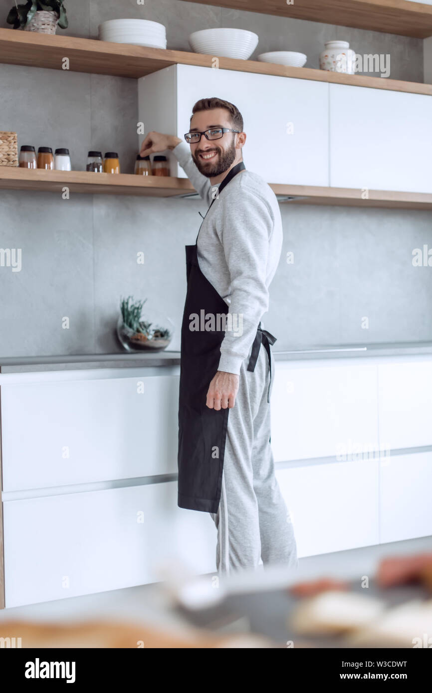 smiling man choosing spices in the kitchen Stock Photo - Alamy