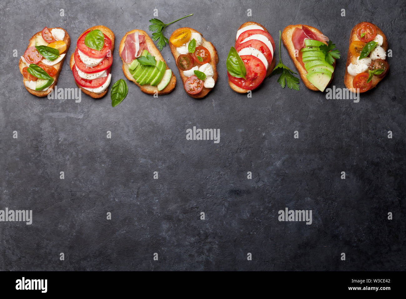 Traditional spanish tapas with tomatoes, mozzarella cheese, avocado and ...