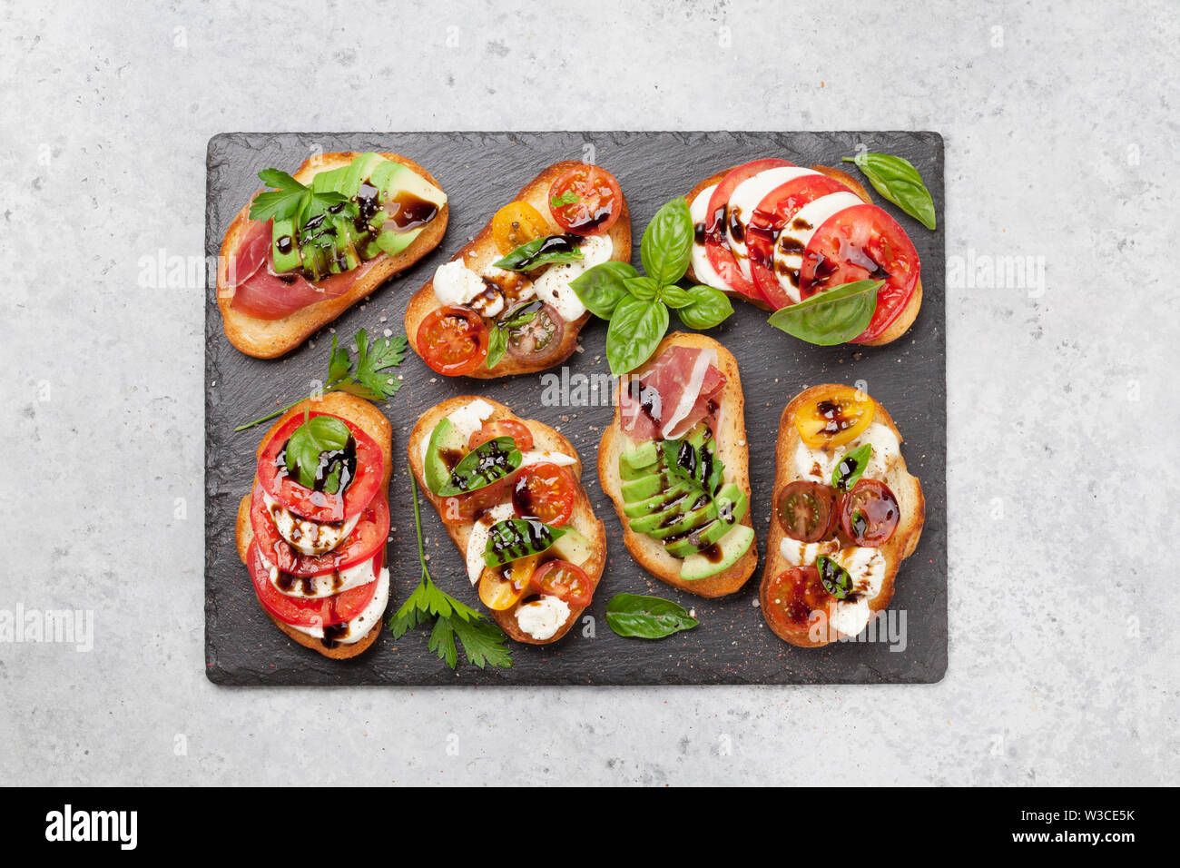 Traditional spanish tapas with tomatoes, mozzarella cheese, avocado and ...