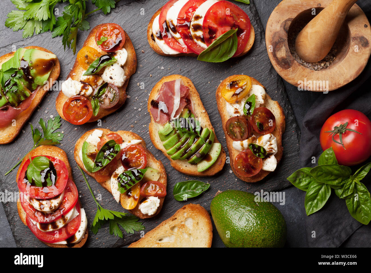 Traditional spanish tapas with tomatoes, mozzarella cheese, avocado and ...
