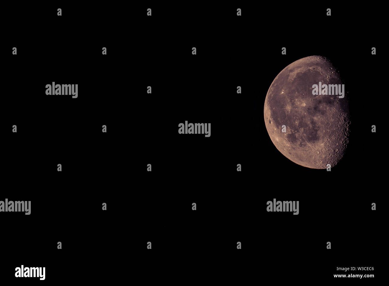 Close up night european golden half-moon phase with details of crater ...