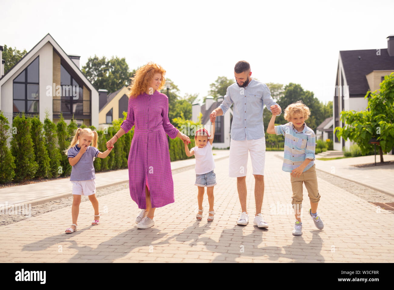 United family. Delighted joyful family standing on the road while ...
