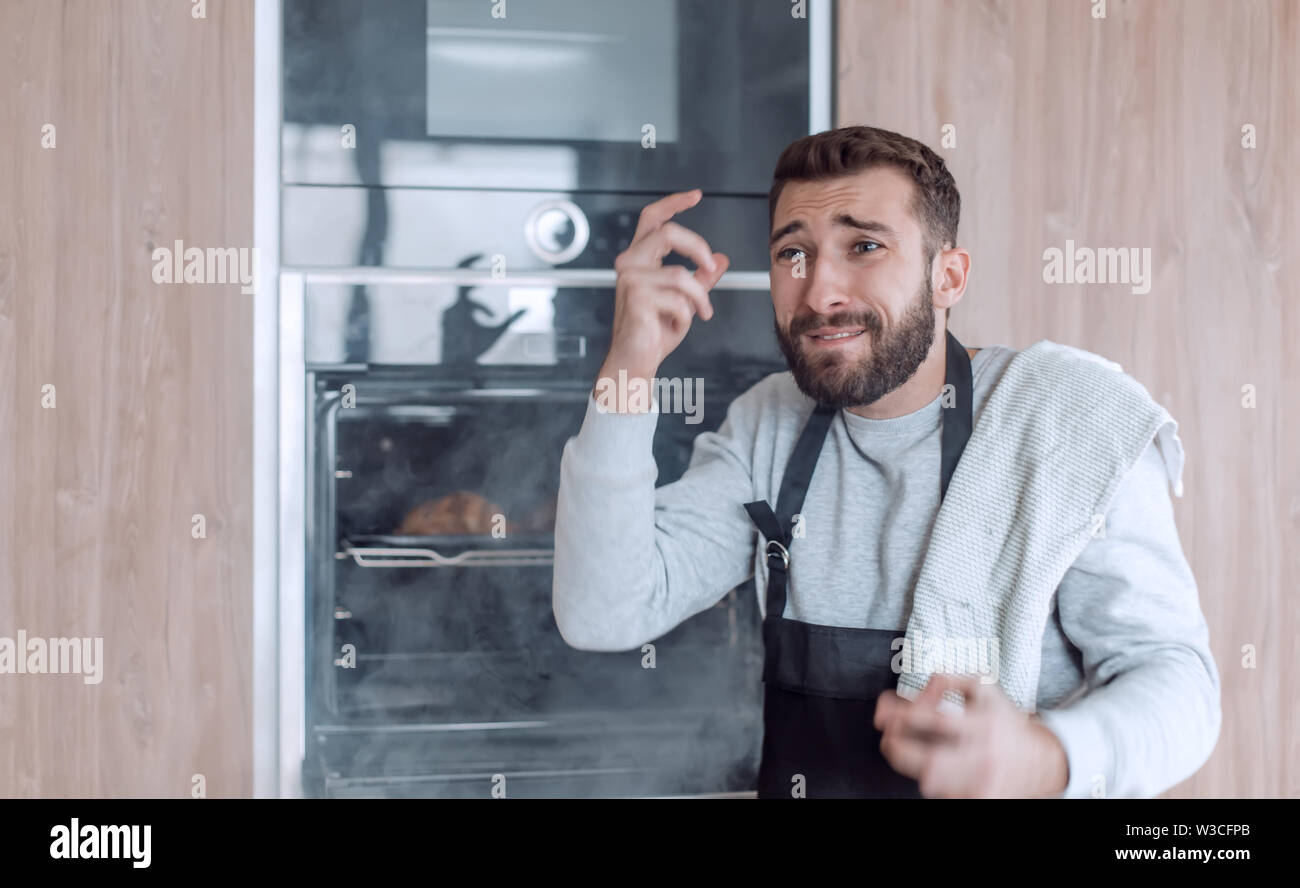 surprised man standing near the oven with burnt croissants Stock Photo ...