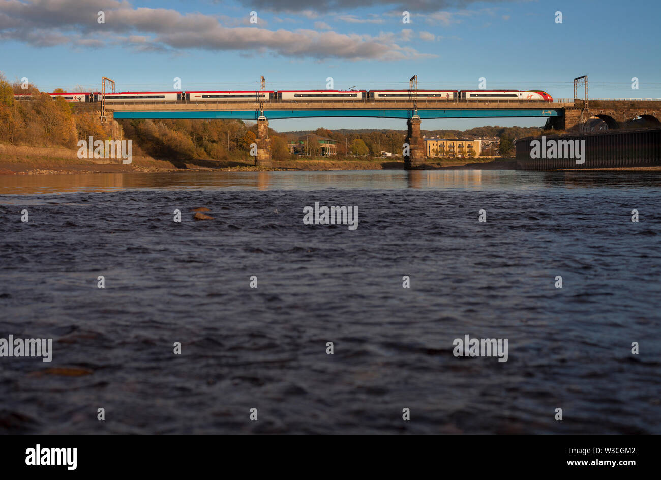 Virgin trains Pendolino train crossing the Carlisle Bridge viaduct over ...