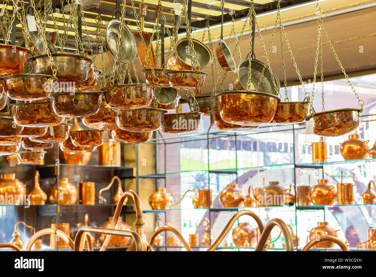 Copper ware, serpentine and jugs on the shop window in the store Stock ...