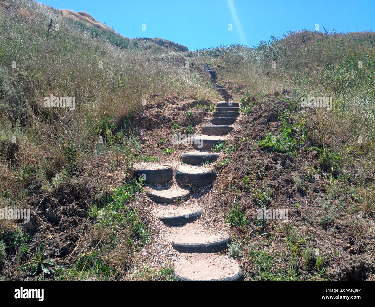 Steps to the top of the hill, made of car treads. Creative from old car ...