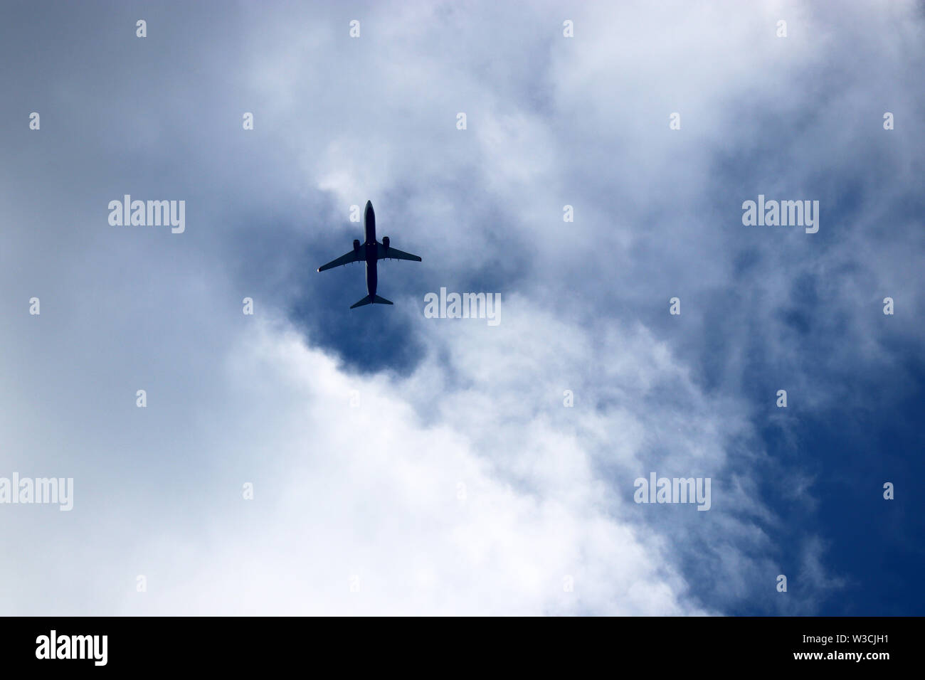 Airplane in the blue sky with white clouds. Commercial plane in a ...
