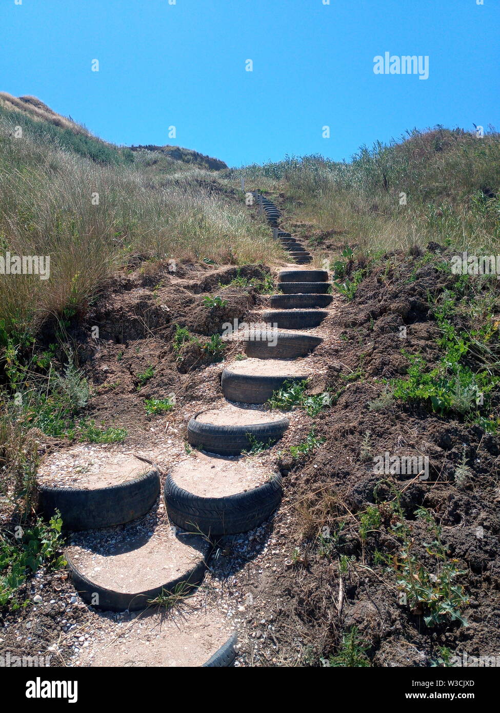 Steps to the top of the hill, made of car treads. Creative from old car ...