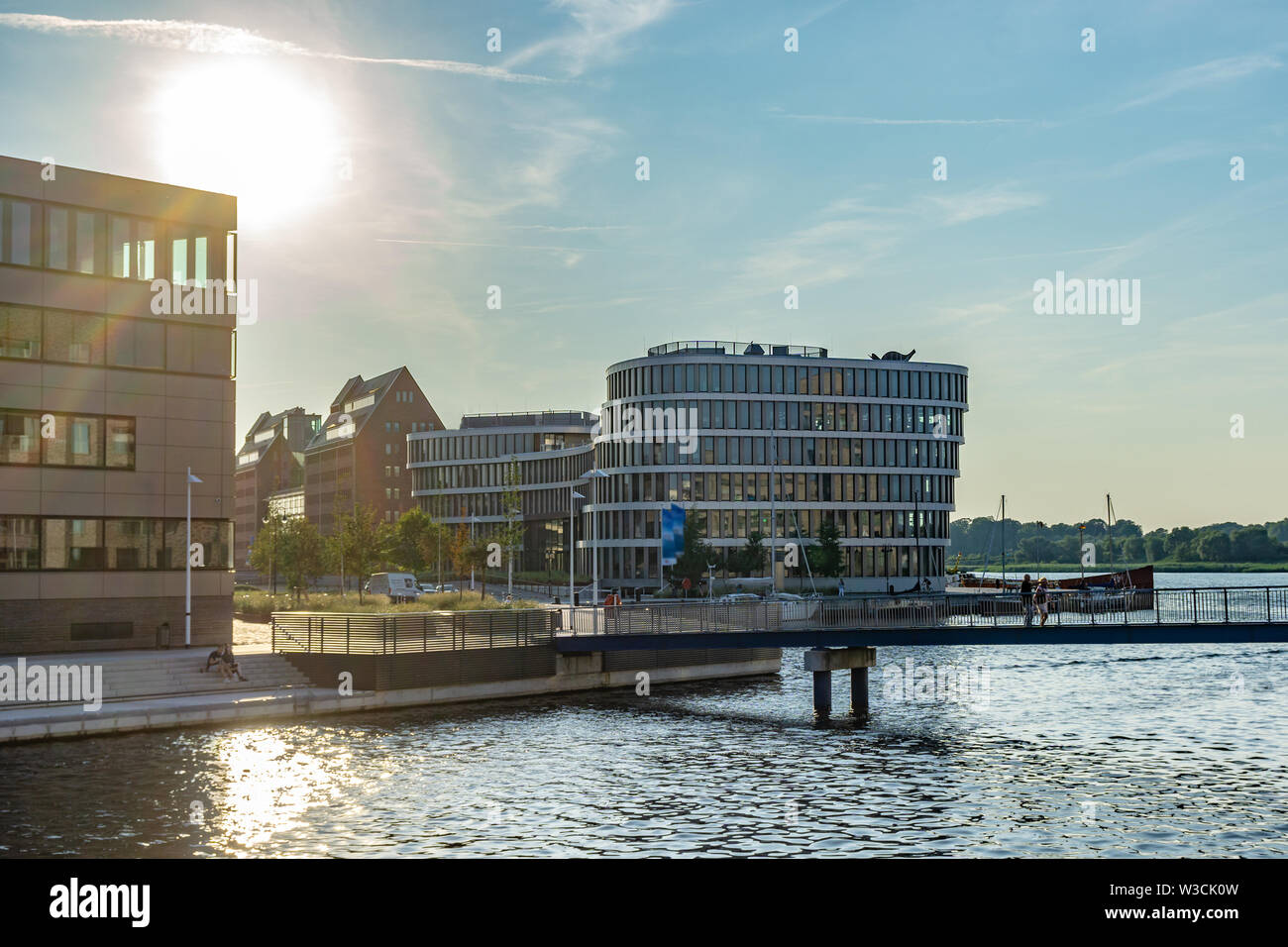 view of the city harbor rostock with modern buildings - sunset sky with ...