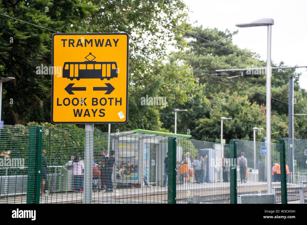 Tramway look both sides warning sign in yellow ear a tram stop Stock ...