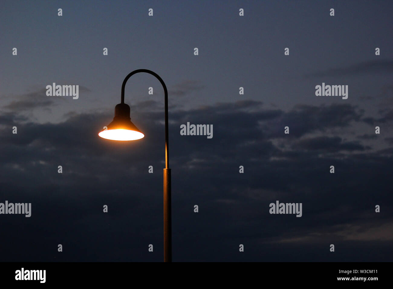 photo of light post on beautiful sky background Stock Photo - Alamy