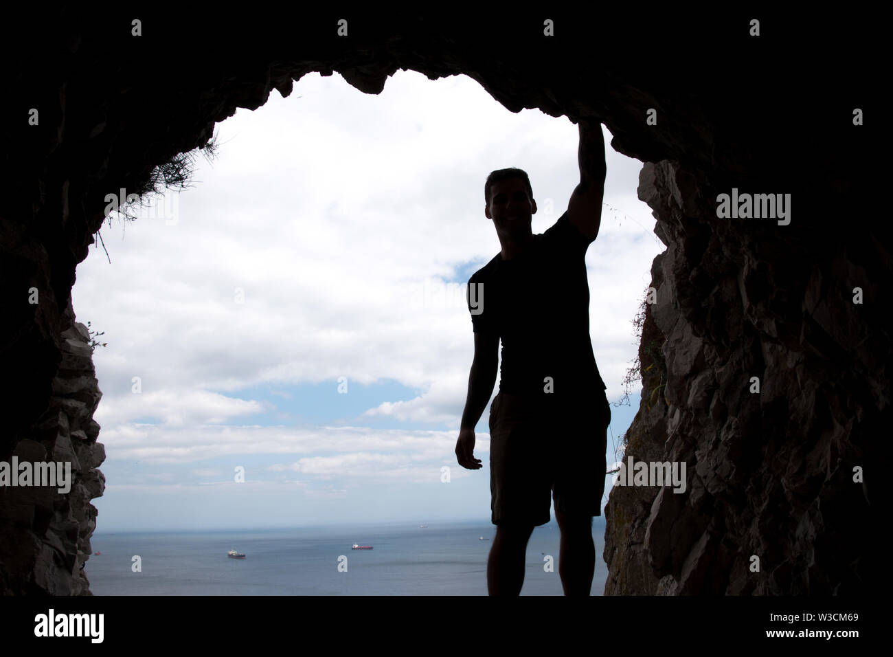 Silhouette of a man overlooking the Straight of Gibraltar from a tunnel ...