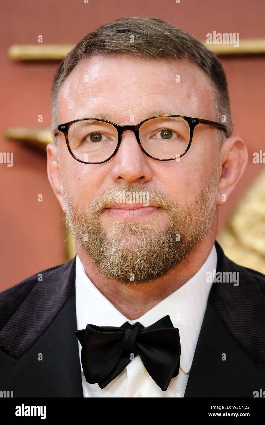 London, UK. 14th July 2019. Guy Ritchie poses on the yellow carpet at ...