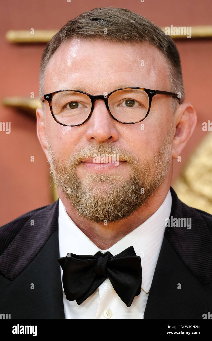 London, UK. 14th July 2019. Guy Ritchie poses on the yellow carpet at ...