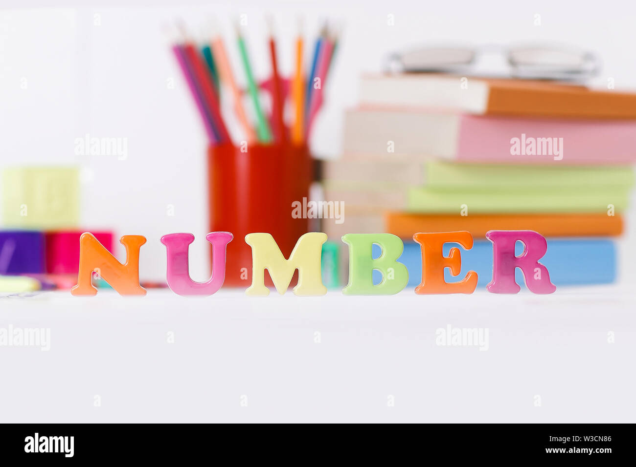 word number on blurred background of school supplies .photo with copy ...