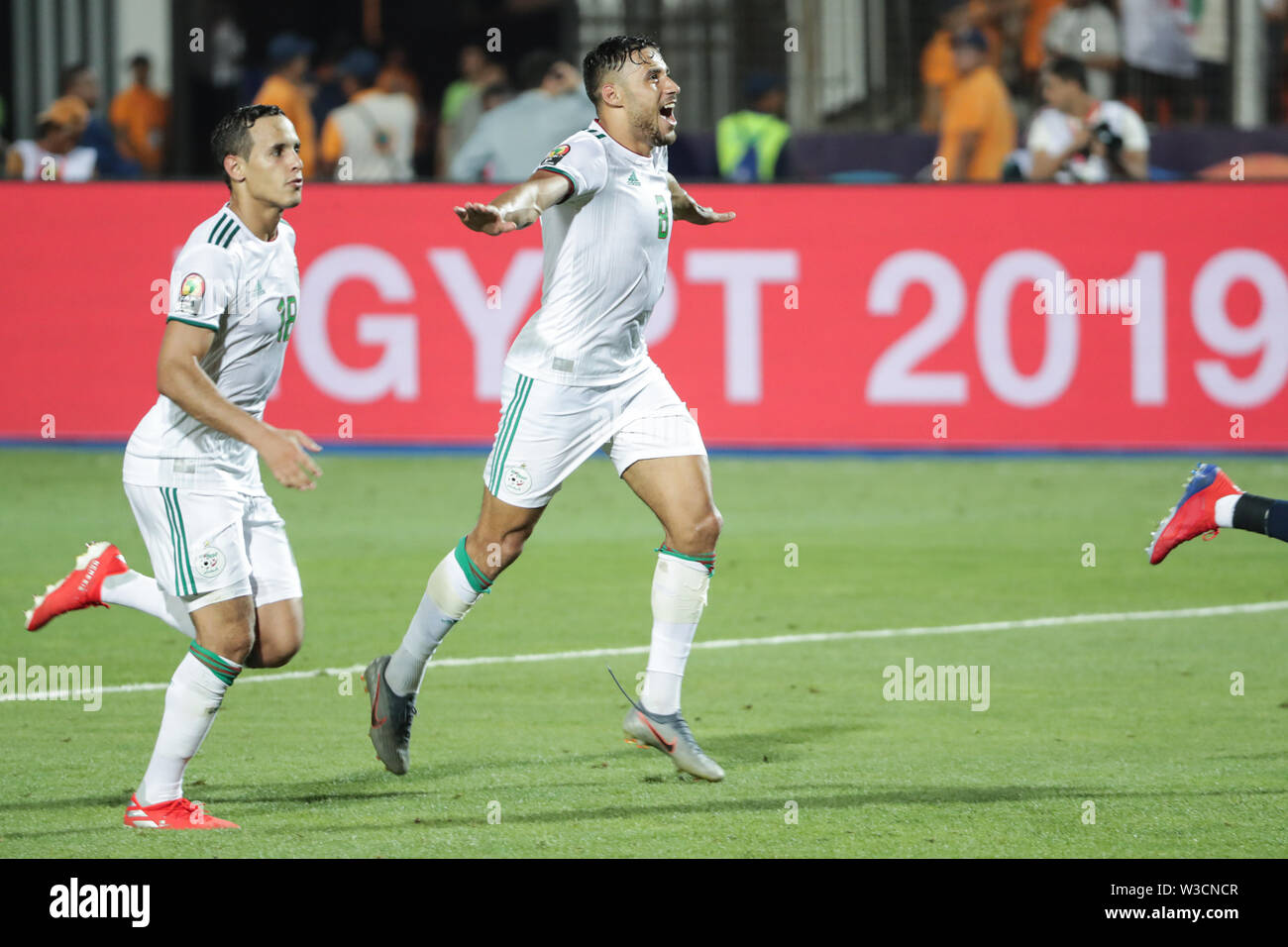 Cairo, Egypt. 14th July, 2019. Algeria's Youcef Belaili (R) and Mehdi Zeffane celebrate after ...